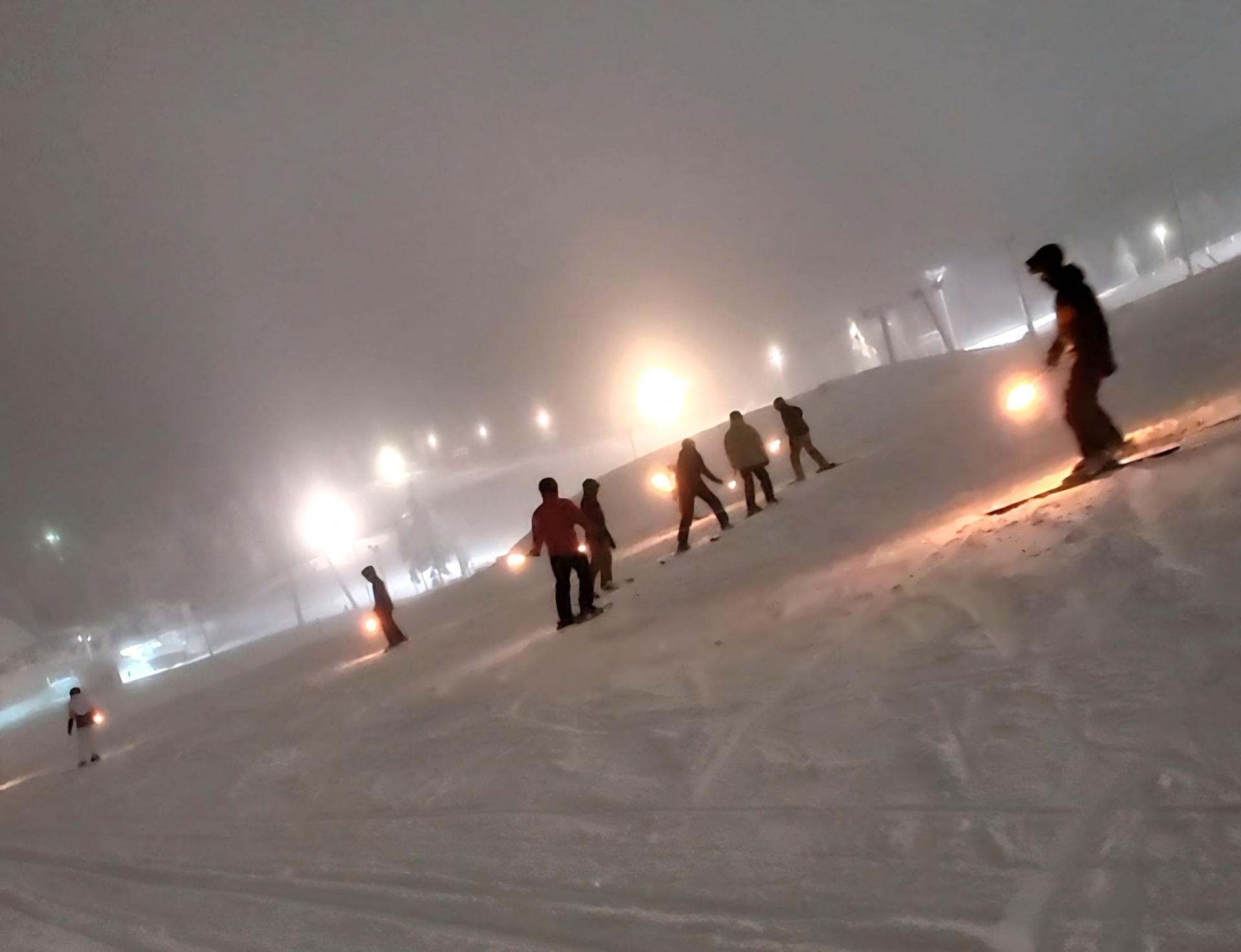 The traditional New Year's torch skiing | Visit Finland